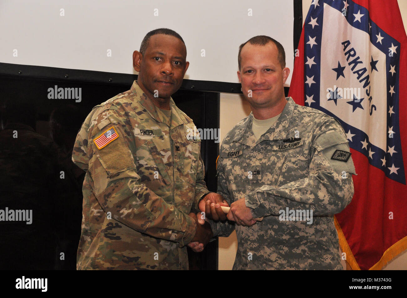Officer Candidate Egnew (right) receives his completion certificate for ...