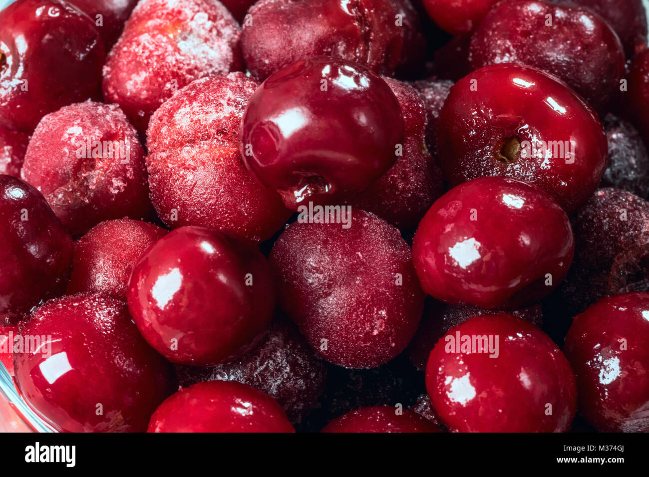 Red berries frozen cherry winter food background Stock Photo - Alamy