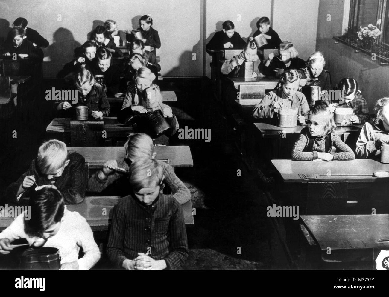 Feeding of school children in a class room after the Second World War ...