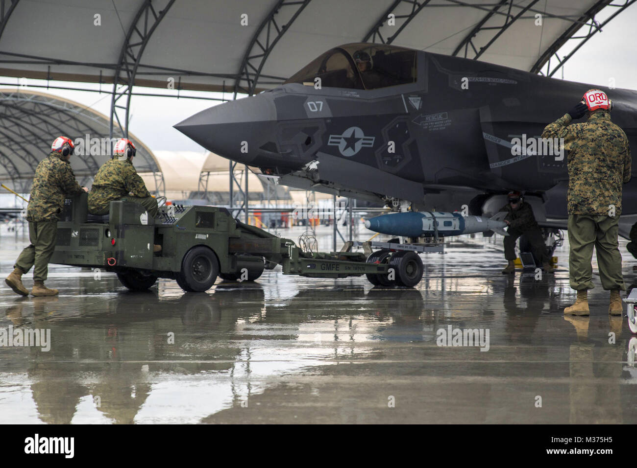 U.S. Marines load ordnance on an F-35B during training at Iwakuni ...