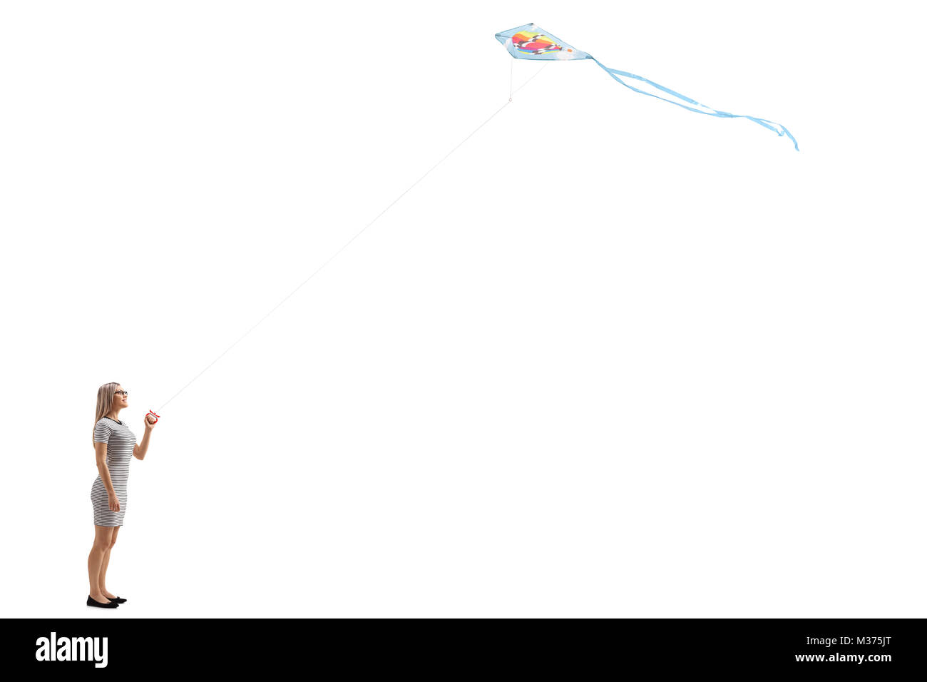 Full length profile shot of a young woman flying a kite isolated on ...