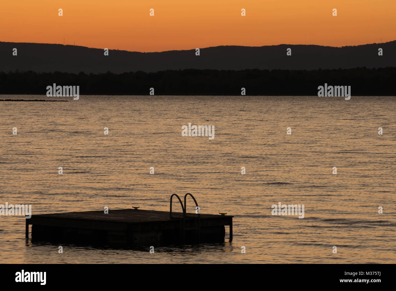 Wooden floating platform by lake at sunset hi-res stock photography and ...