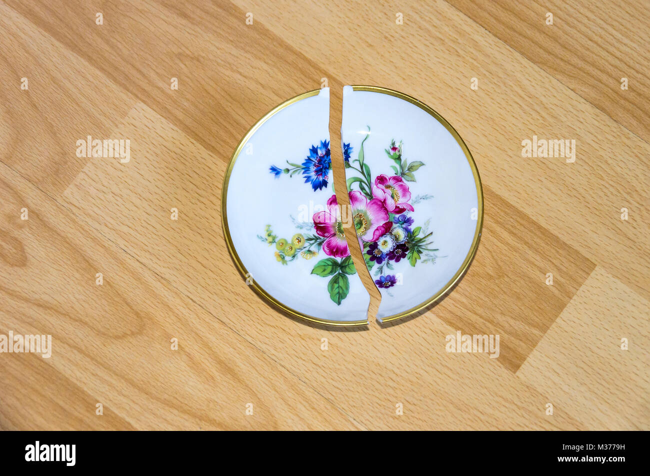 Broken china plate on the floor Stock Photo - Alamy
