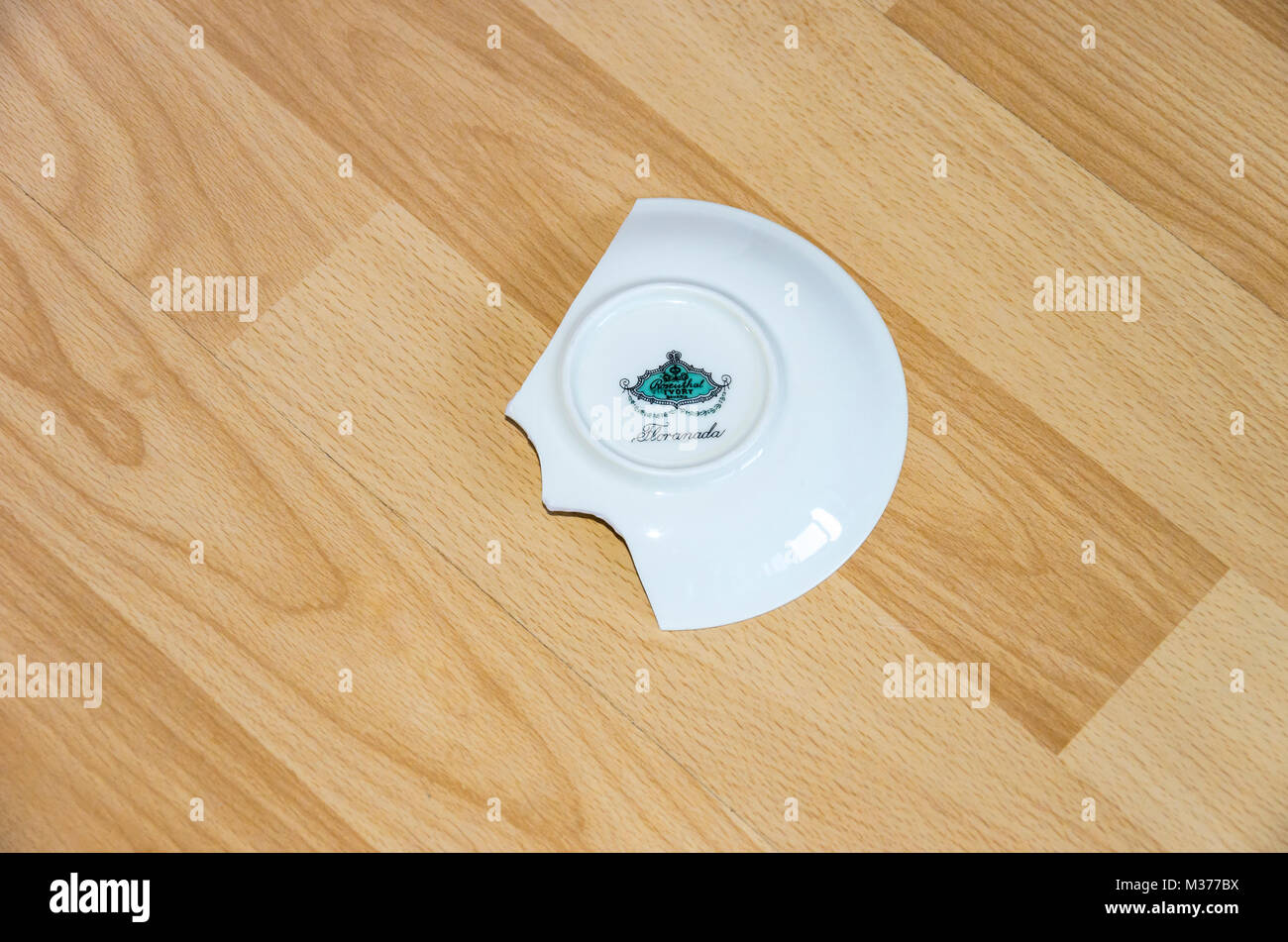 Broken china plate on the floor Stock Photo - Alamy
