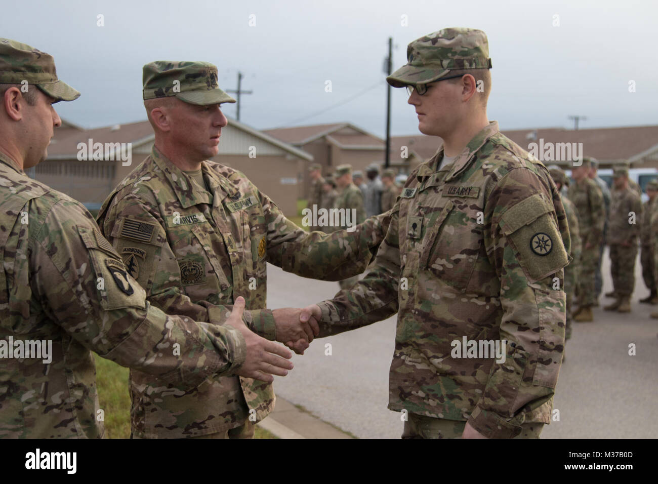 Spc. Austen Thilges shakes hands with Cpt. Keith Twichell and 1st Sgt ...