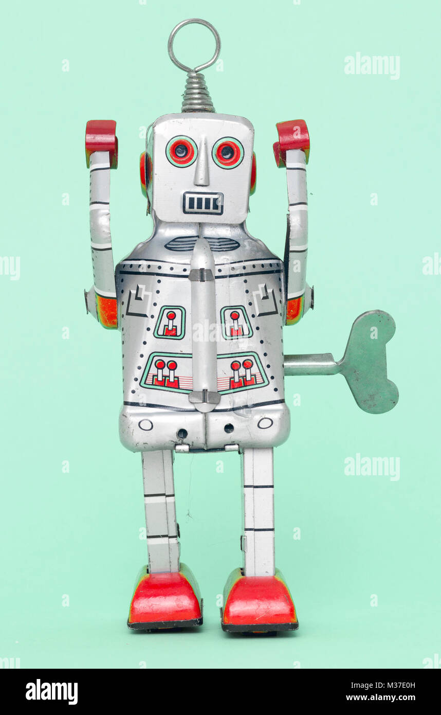 little silver robot with hands up on green Stock Photo - Alamy