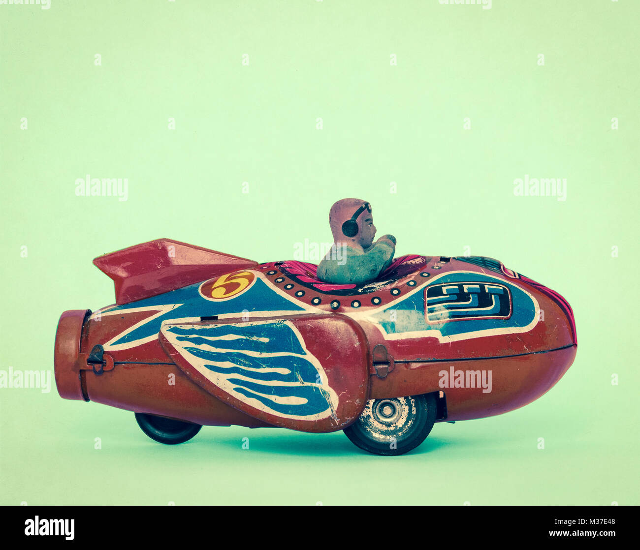 little red rocket on lime green background Stock Photo - Alamy