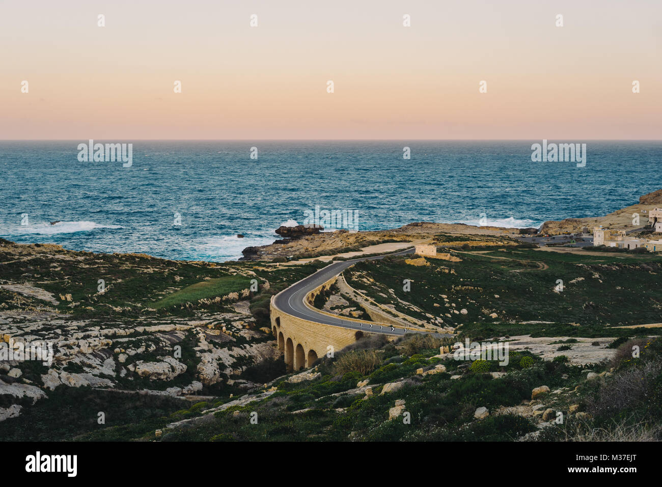 Island of Gozo, Malta. Dwejra Bay at sunrise with ancient stone bridge ...