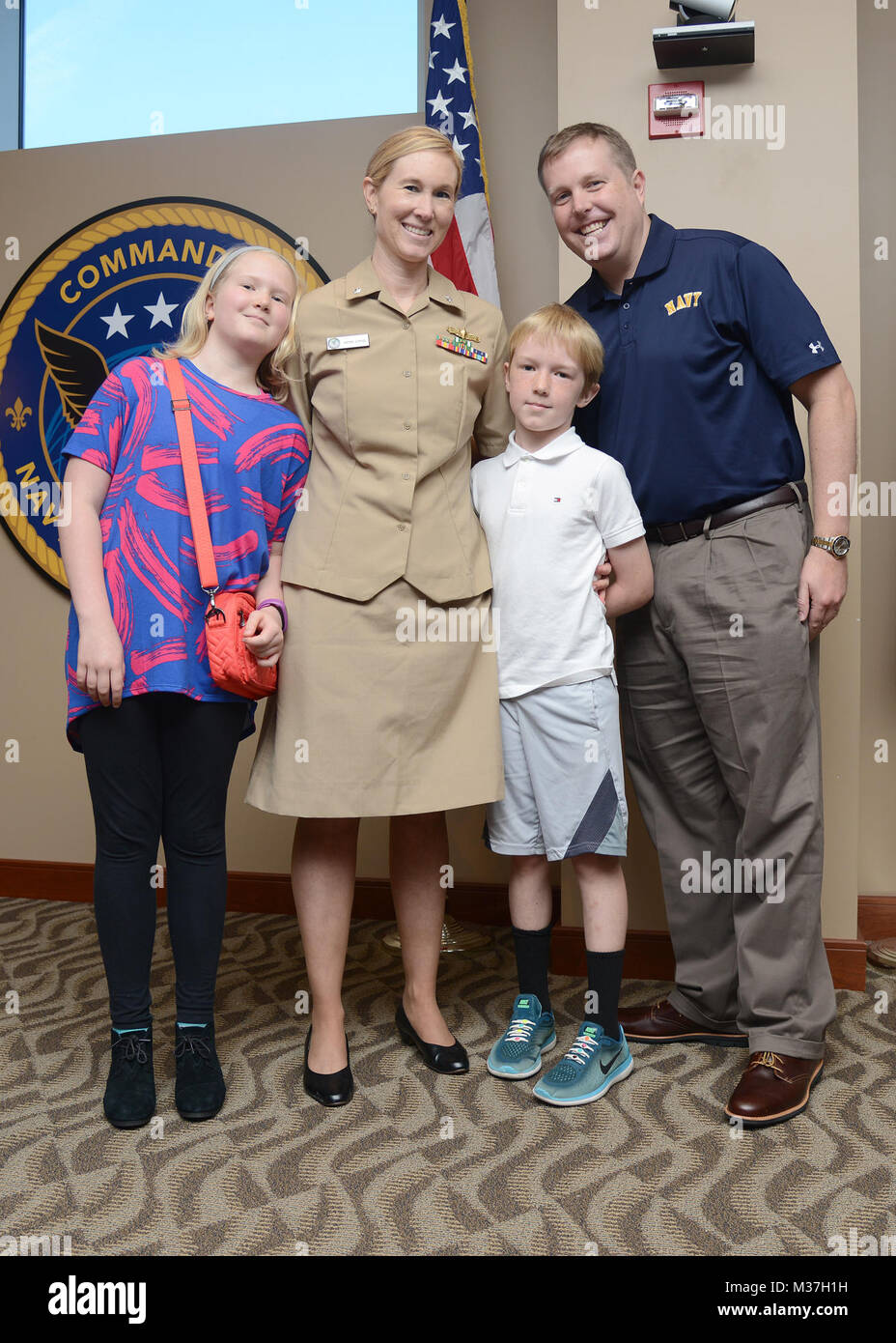 Lieutenant Commander Kerri Chase pose for a family photo following her ...