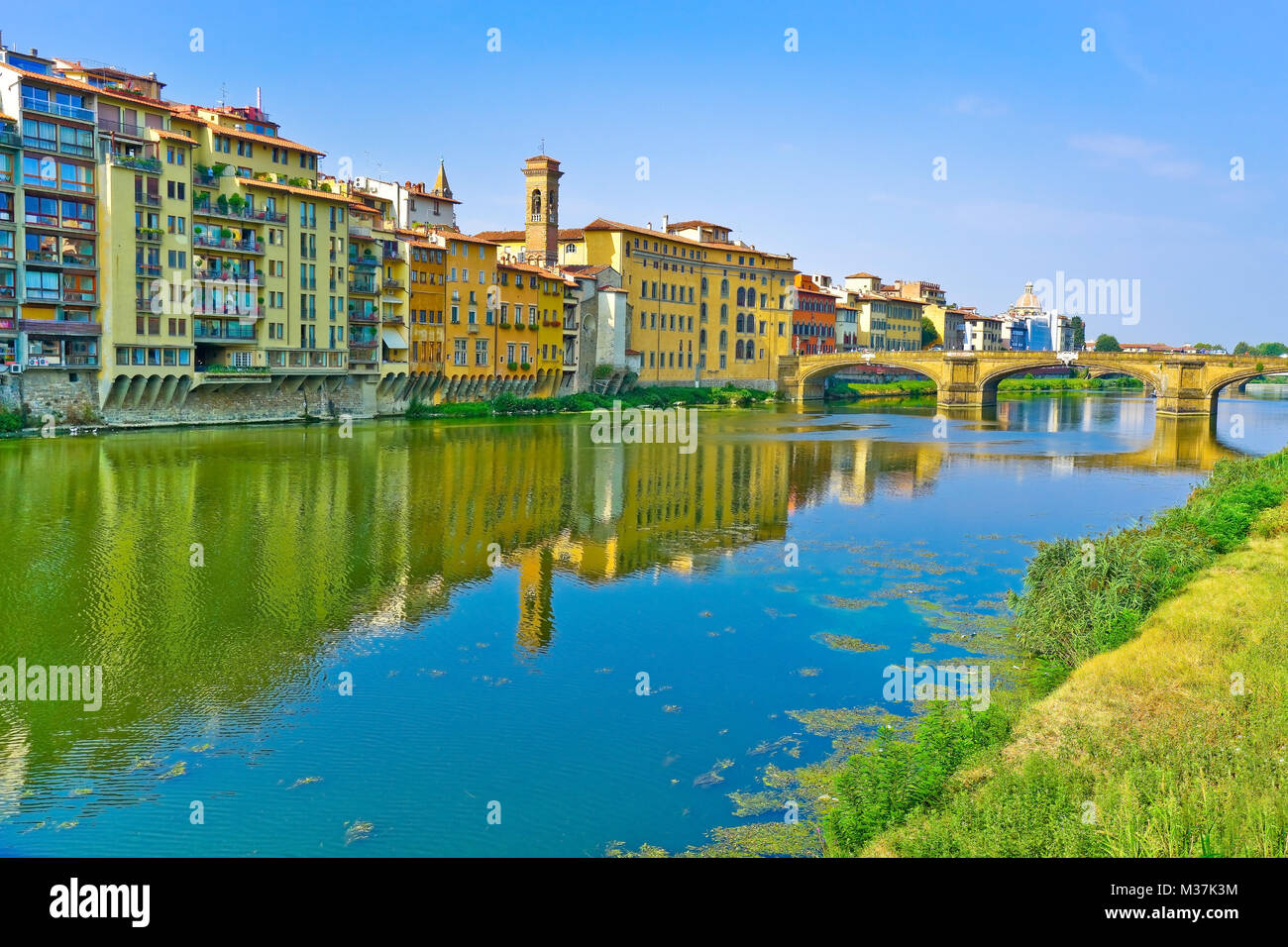 View of the Old Bridge across the Arno River in Florence on a sunny day ...