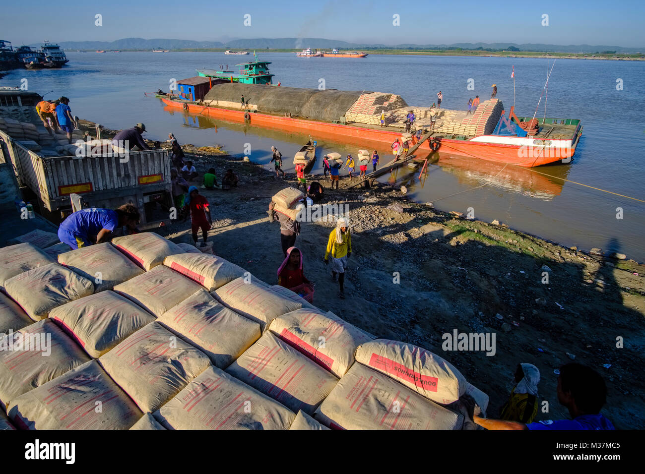 Man carrying cement bag hi-res stock photography and images - Alamy