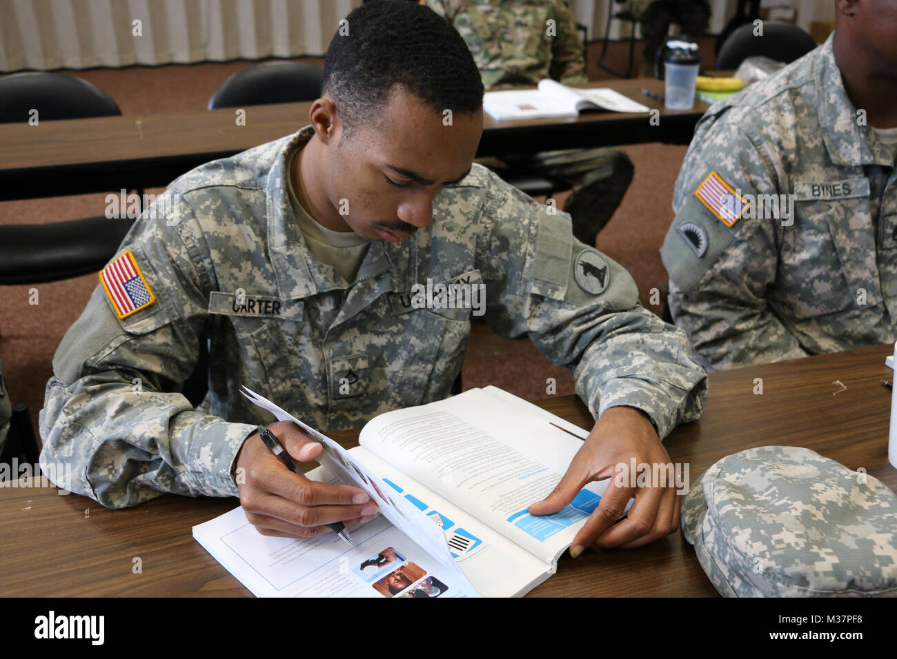 Pfc. Devon Carter of the 1049th Transportation Company reviews the ...