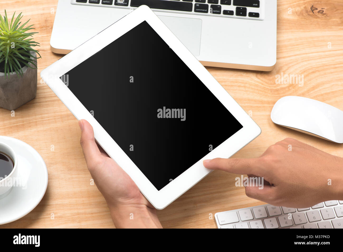Hand using digital tablet with blank screen on desk work table Stock ...