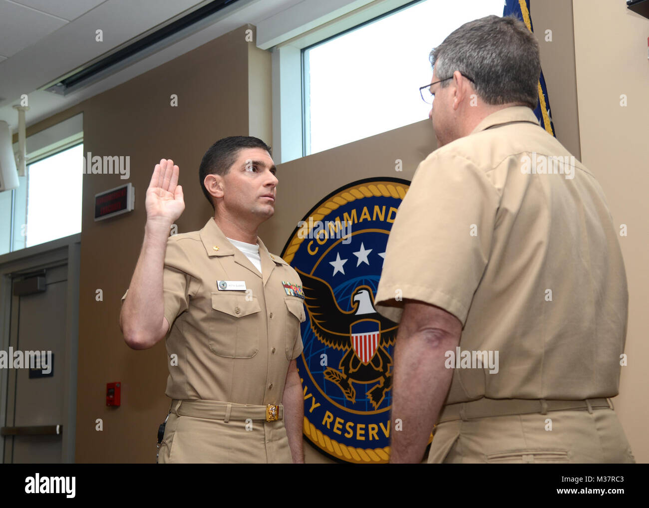 Lieutenant Commander Keith Bushey takes the Oath of Office as part of ...