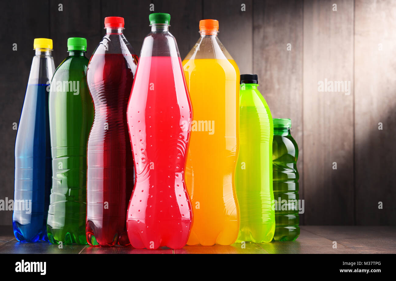 Plastic bottles of assorted carbonated soft drinks in variety of colors ...