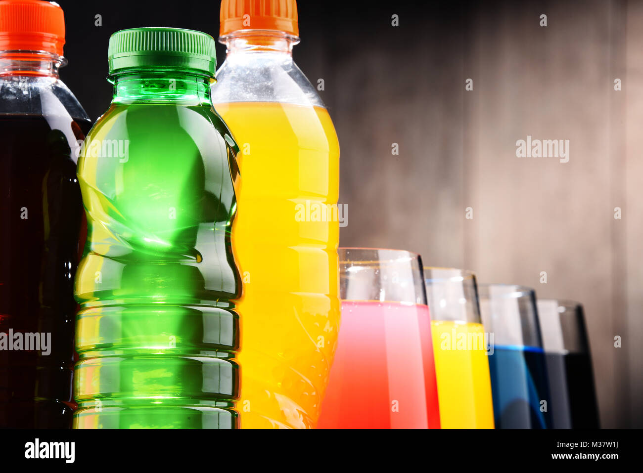 Glasses and bottles of assorted carbonated soft drinks in variety of ...