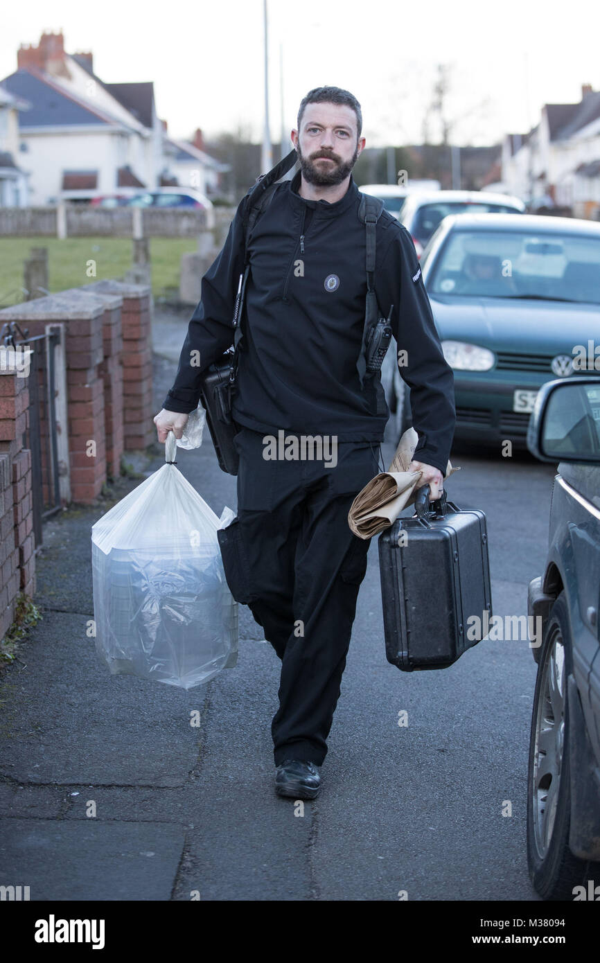 A forensic police officer carries bags along Kent Road, Wolverhampton ...
