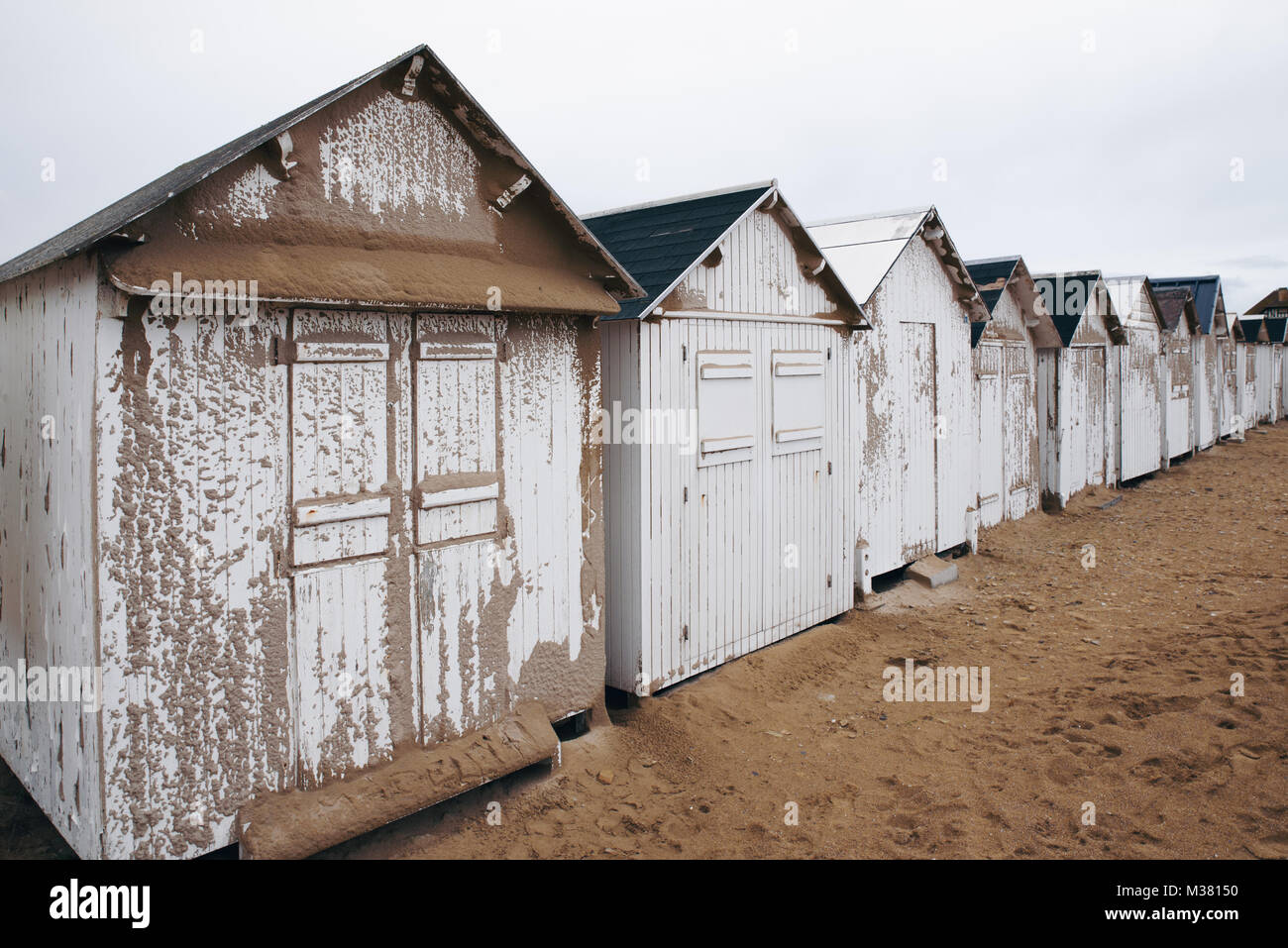 White bathing beach houses, cabins in a row on the beach Stock Photo ...