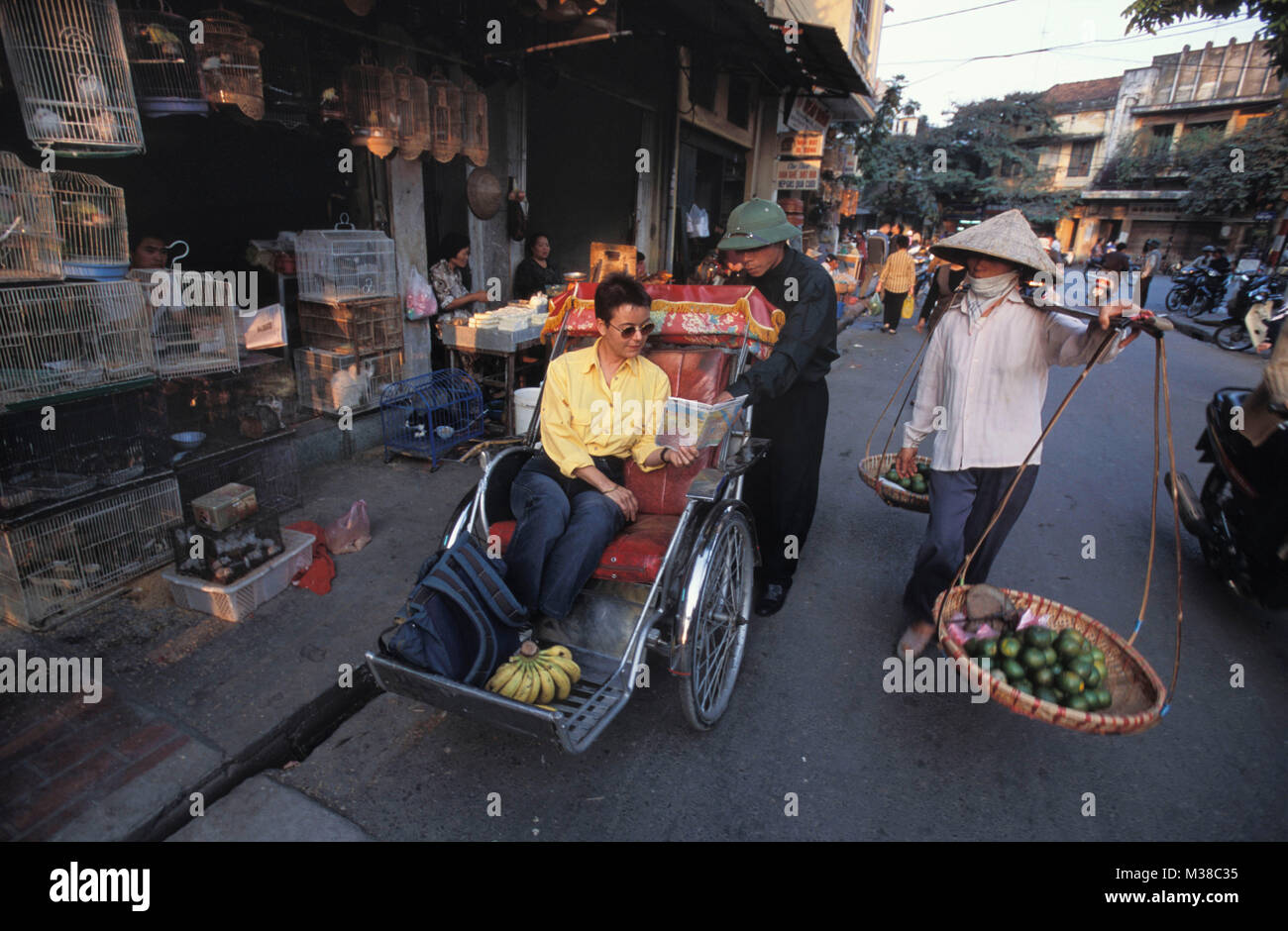 Vietnam. Hanoi. Old quarter. Rickshaw. Cyclo driver. Tourist, woman ...