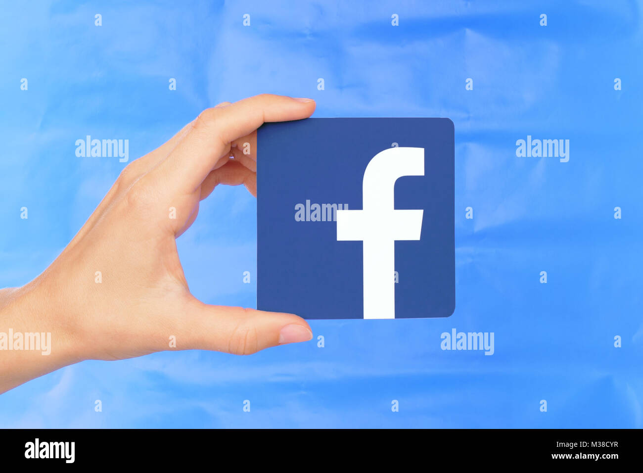 Kiev, Ukraine - September 4, 2017: Hand holds Facebook icon printed on ...