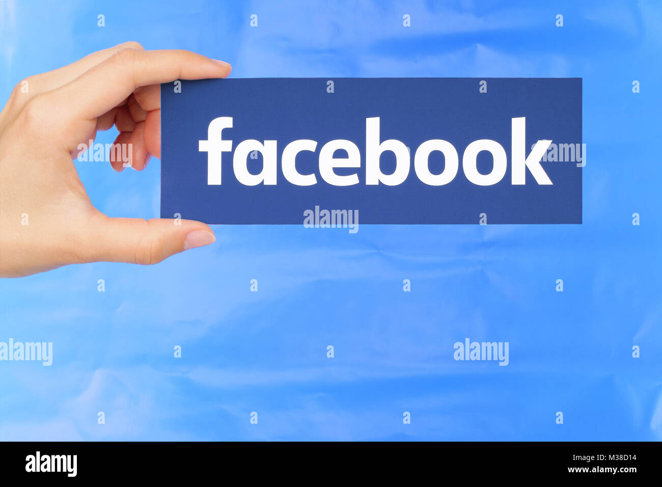 Kiev, Ukraine - September 4, 2017: Hand holds Facebook logo printed on ...