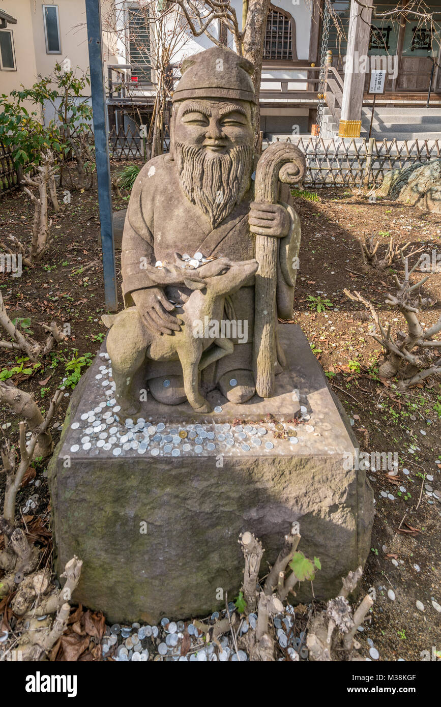 Kamakura, Japan - November 22, 2017 : Coins around statue of Jurojin ...