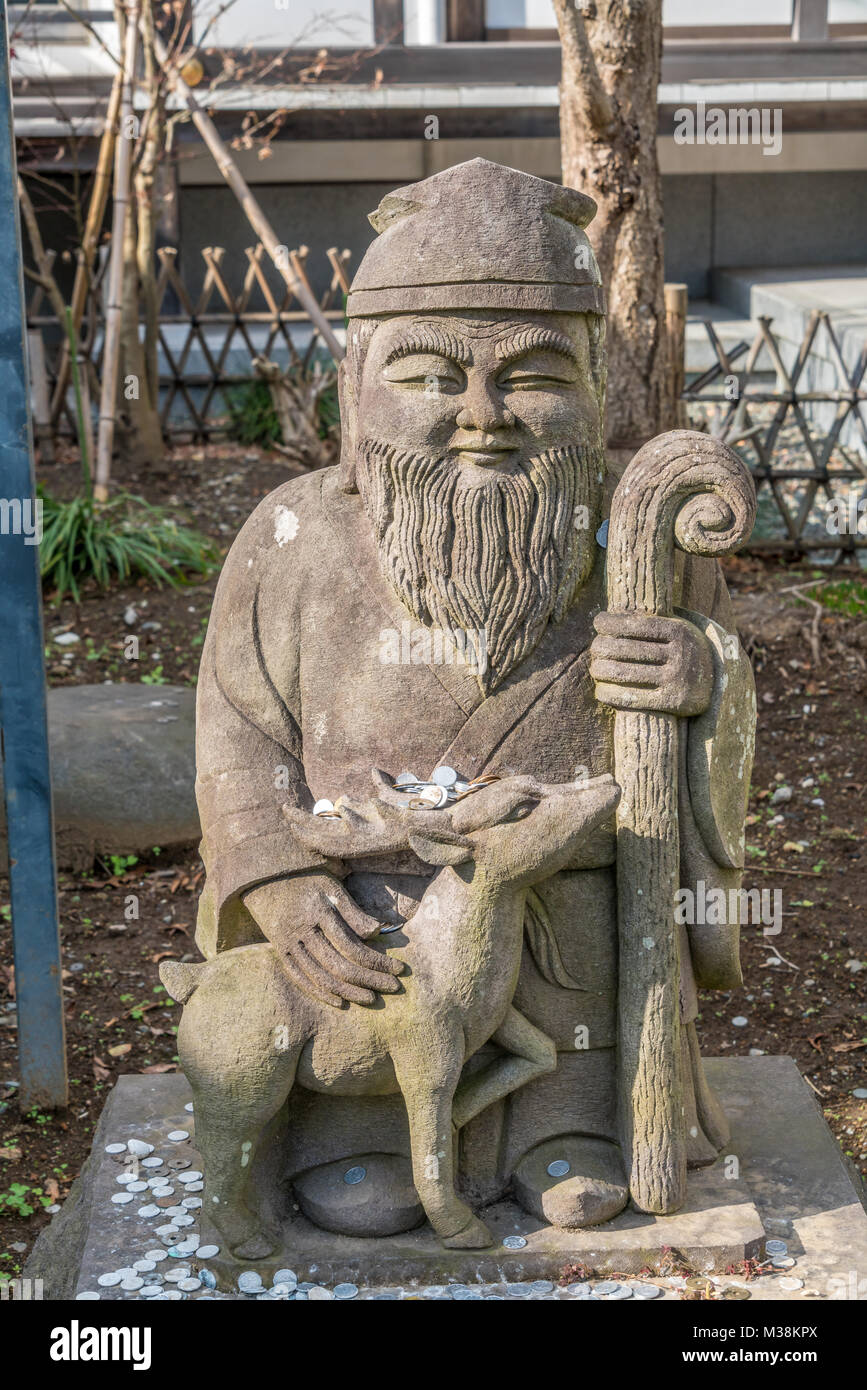 Kamakura, Japan - November 22, 2017 : Coins around statue of Jurojin ...