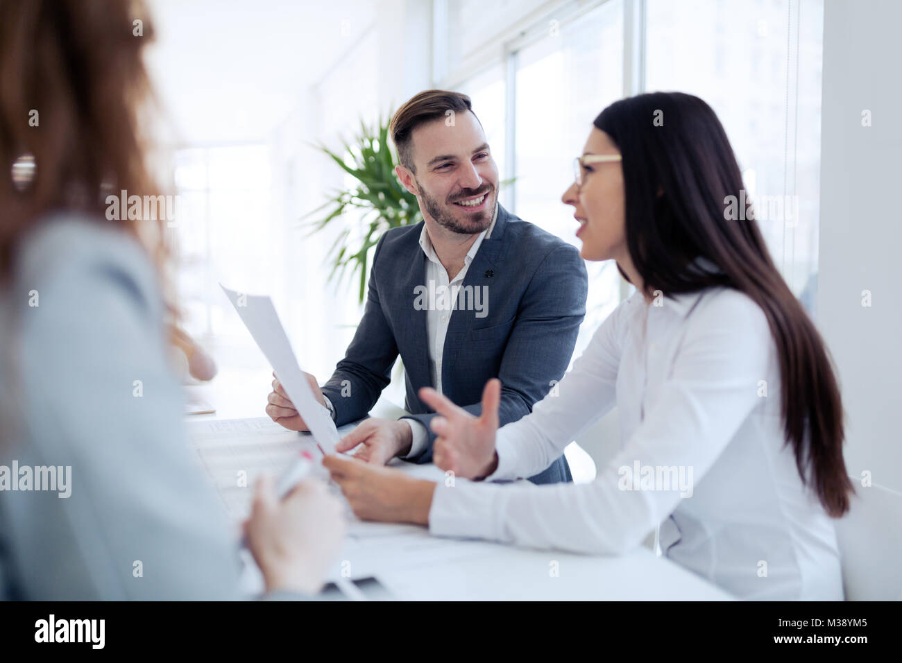 Happy colleagues casual chat at the office Stock Photo - Alamy