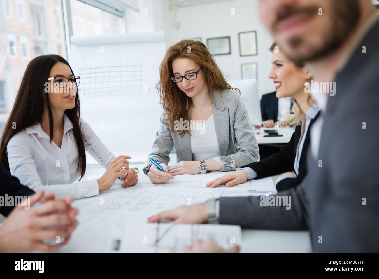 Group of architects working together on project Stock Photo - Alamy