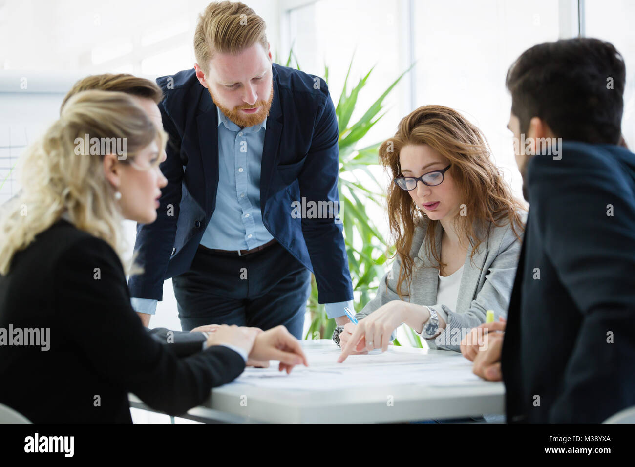 Business colleagues collaborating and discussing project plans Stock ...