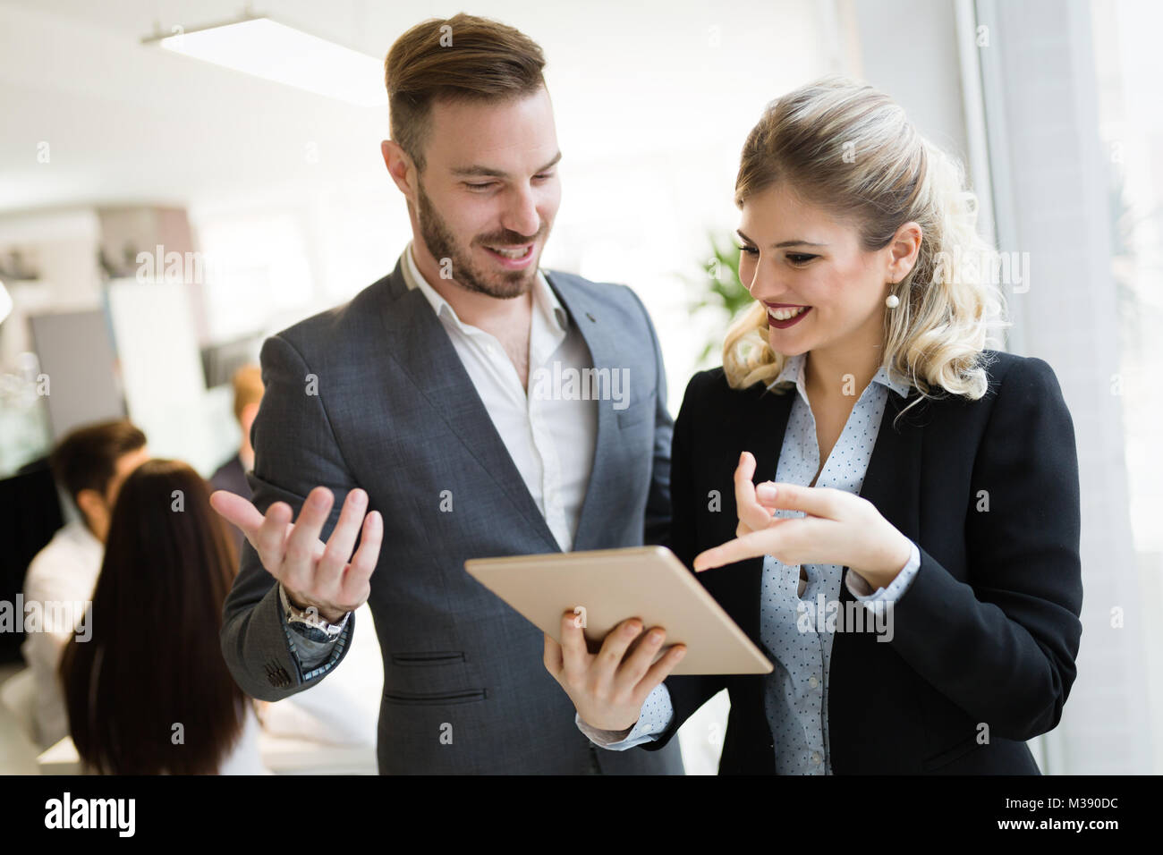 Happy colleagues casual chat at the office Stock Photo - Alamy