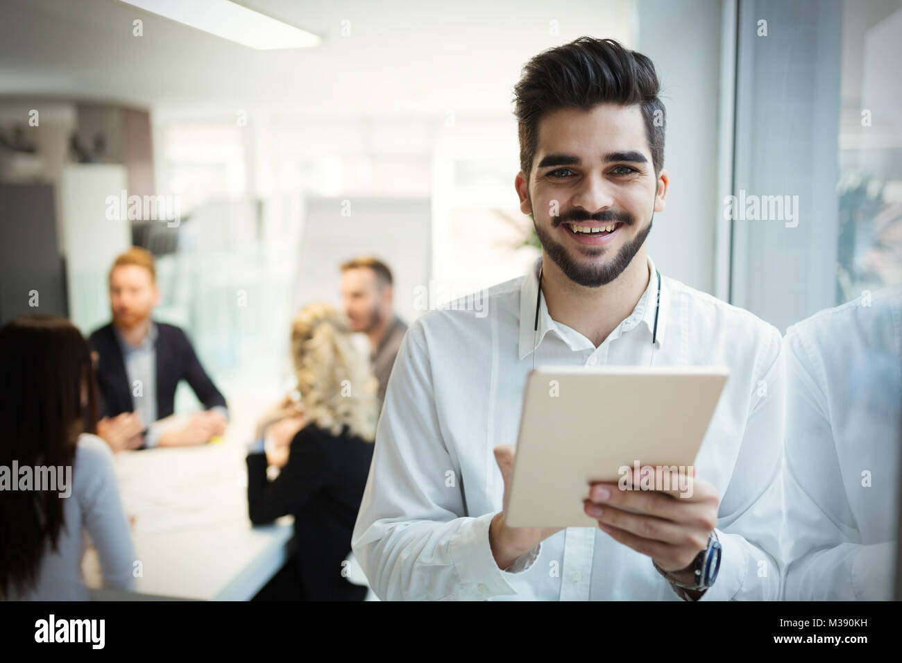 Handsome businessman using tablet pc in office Stock Photo - Alamy