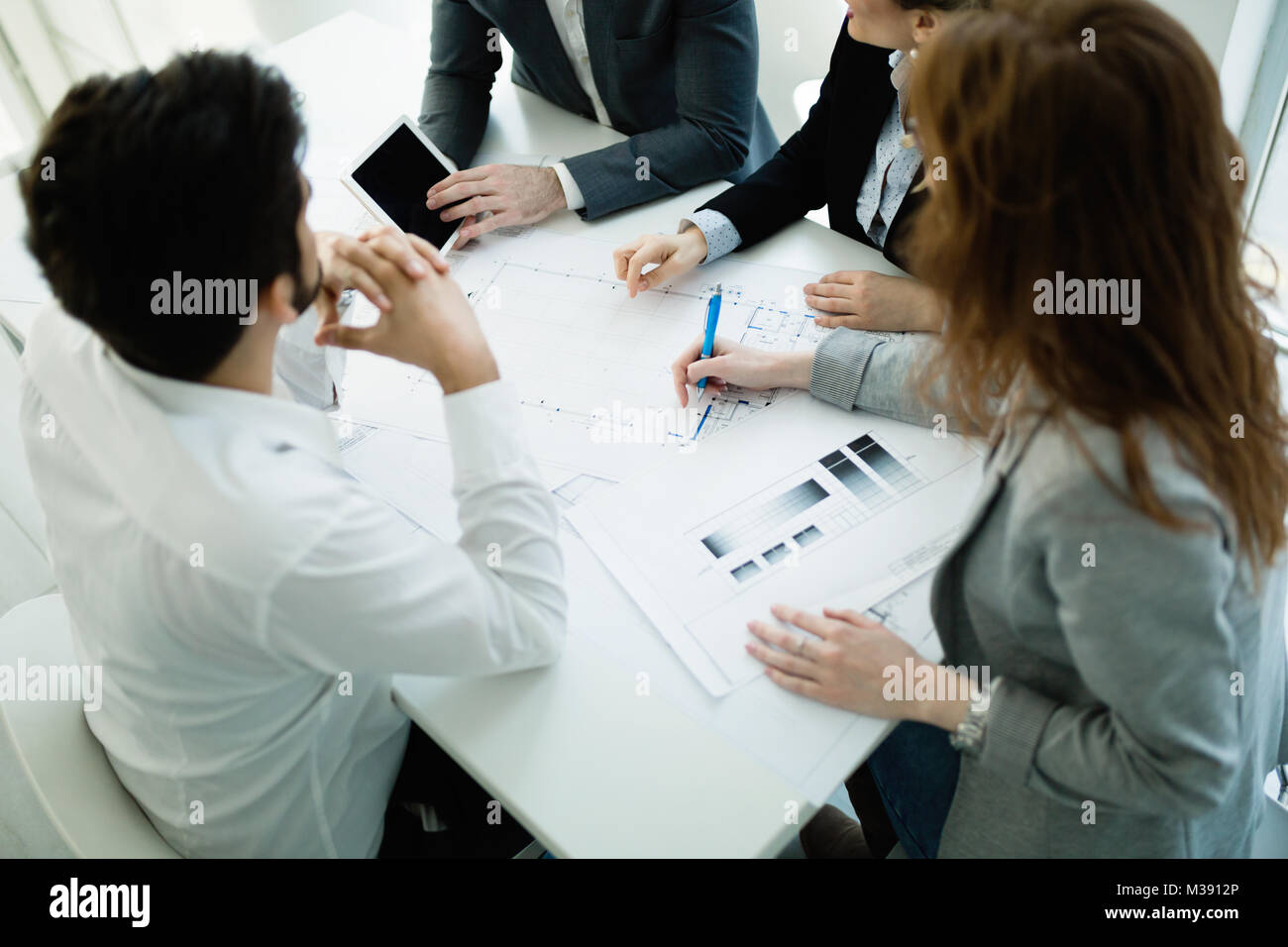 Portrait of architects having discussion in office Stock Photo - Alamy