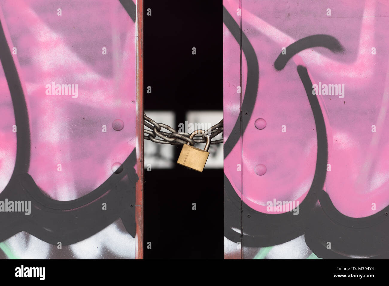 Pink doors closed with gold lock and chain. Warehouse entrance Stock ...