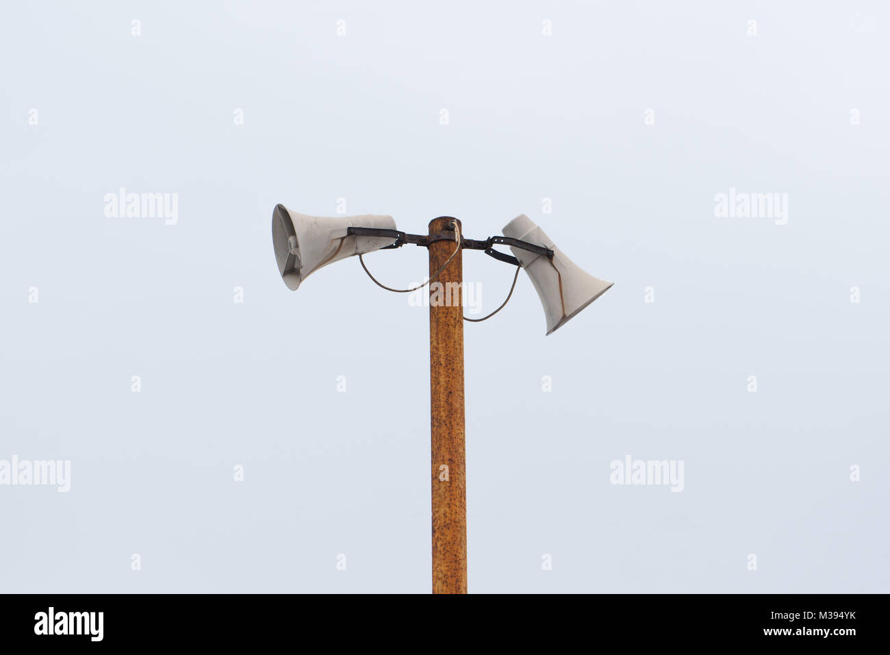 Old outdoor white loudspeakers, megaphones on a rusty metal pole Stock ...