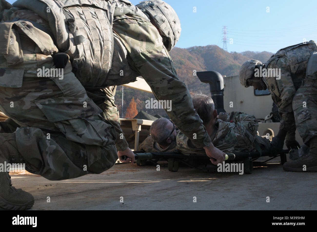 U.S. Army Soldiers, assigned to I Corps, load simulated casualties in a ...
