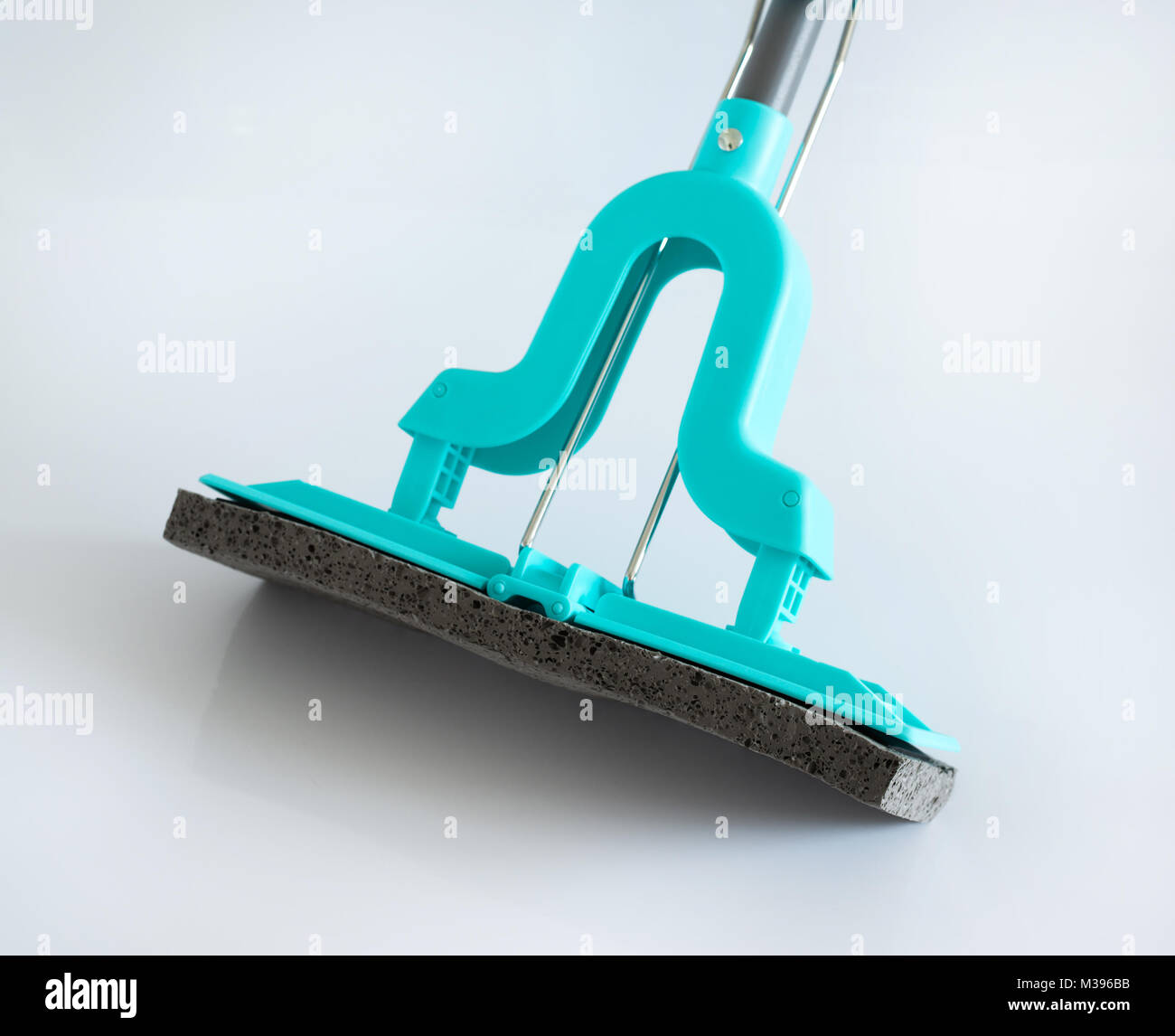 Blue mop for washing the floor on a light background Stock Photo - Alamy