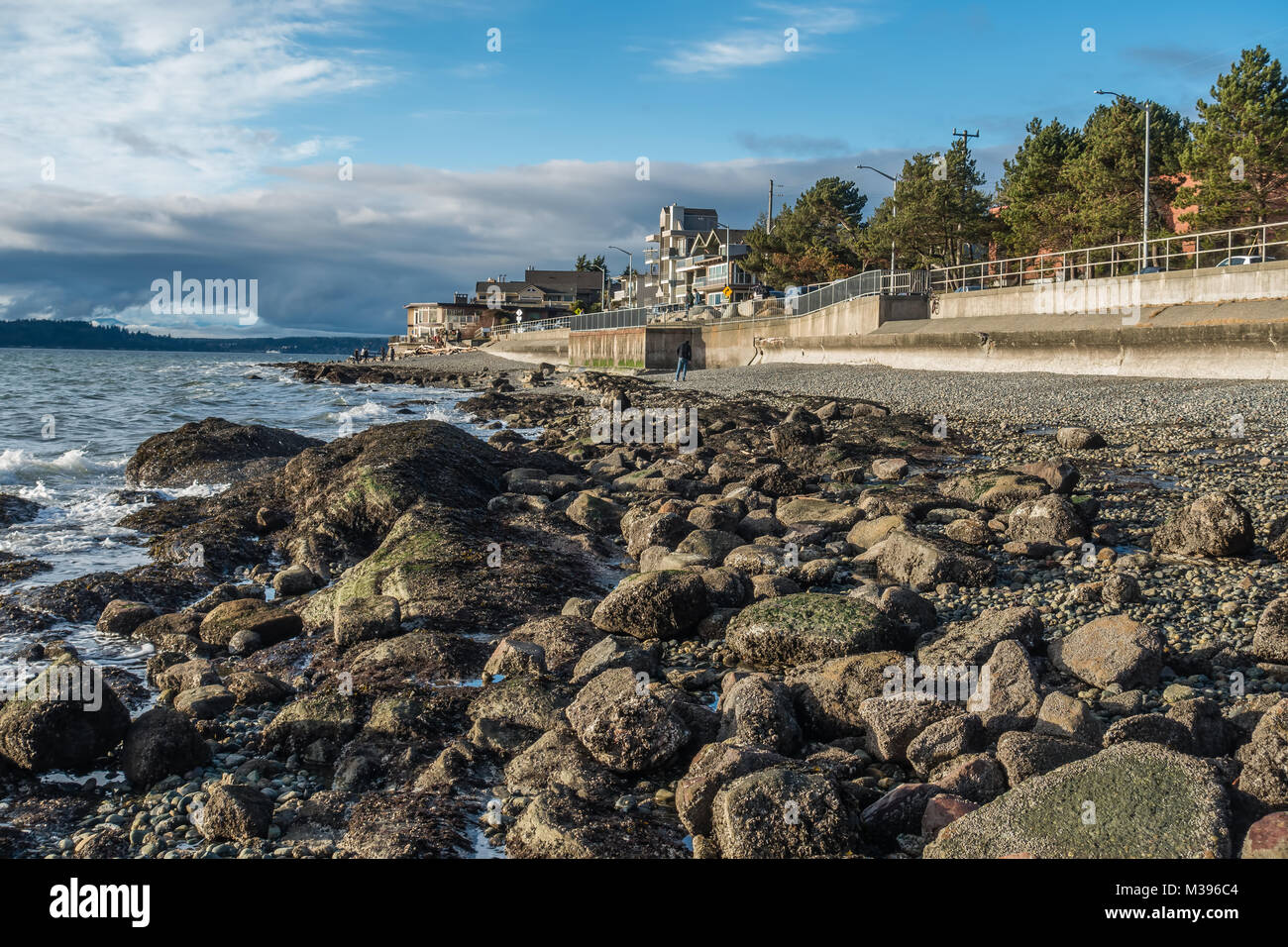 A veiw of the rocky shoreline in West Seattle, Washington Stock Photo ...