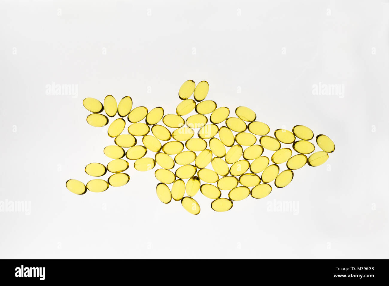 Backlit fish oil capsules in shape of fish on white background Stock ...