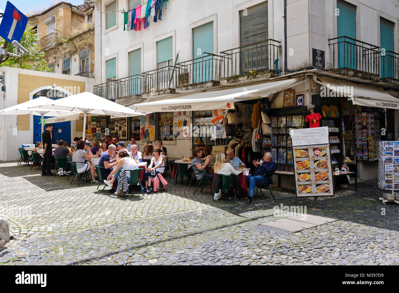 People sitting outside a cafe in Lisbon, Portugal Stock Photo - Alamy