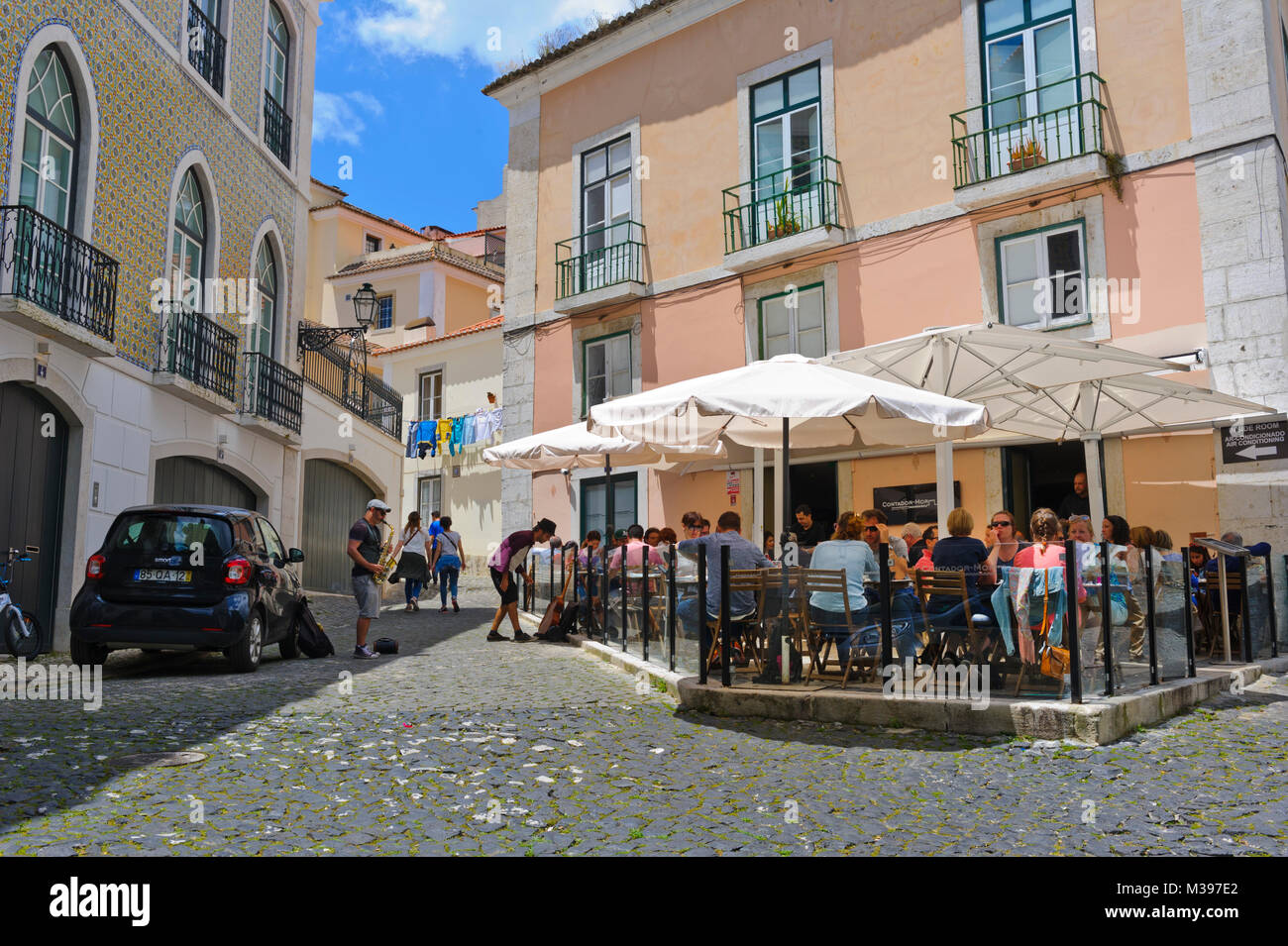 People sitting outside a cafe in Lisbon, Portugal Stock Photo - Alamy