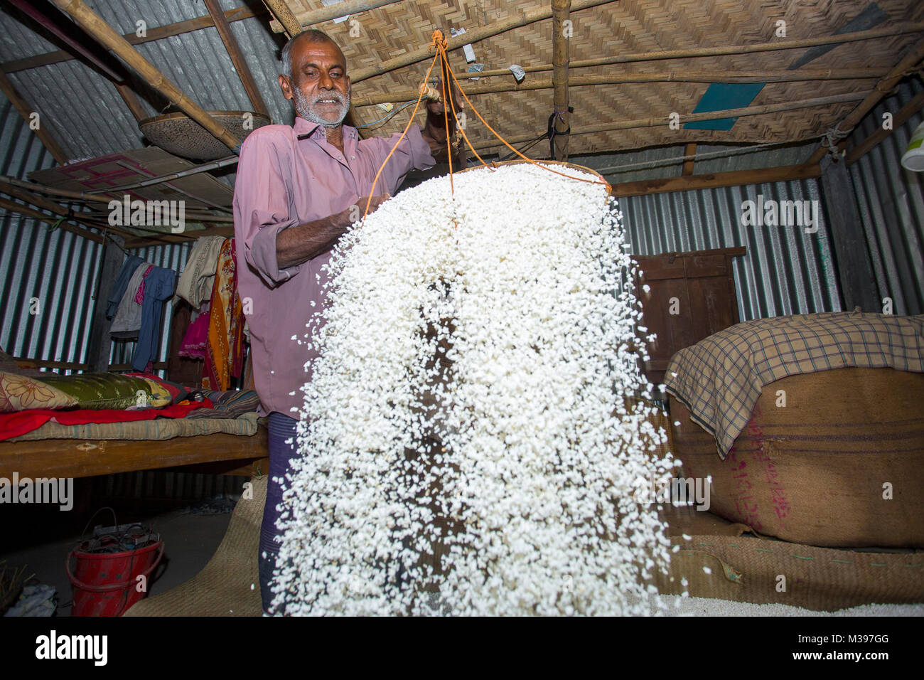 Abu syed ali, khoi (popped rice) making business he is holding them 34 ...