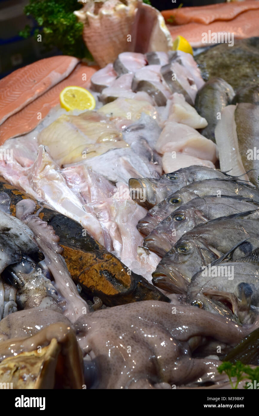 Fresh fish for sale on a wet fish fishmongers market stall at borough ...