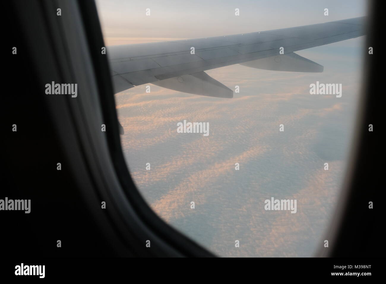 Clouds and sky seen through window of an aircraft in sunset time Stock ...