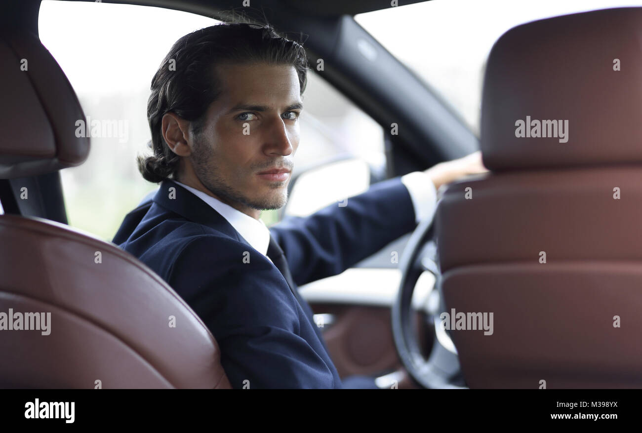 man sitting behind the wheel of a car Stock Photo - Alamy