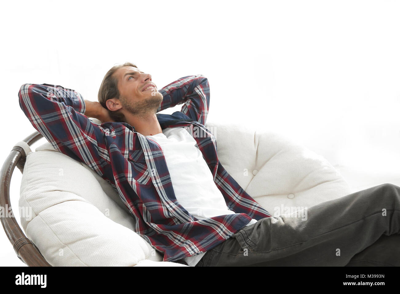 serious guy rests sitting and dreaming in a large comfortable chair ...