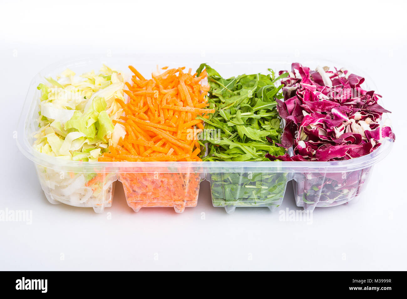 Mix salad vegetables in plastic box isolated on white background Stock ...