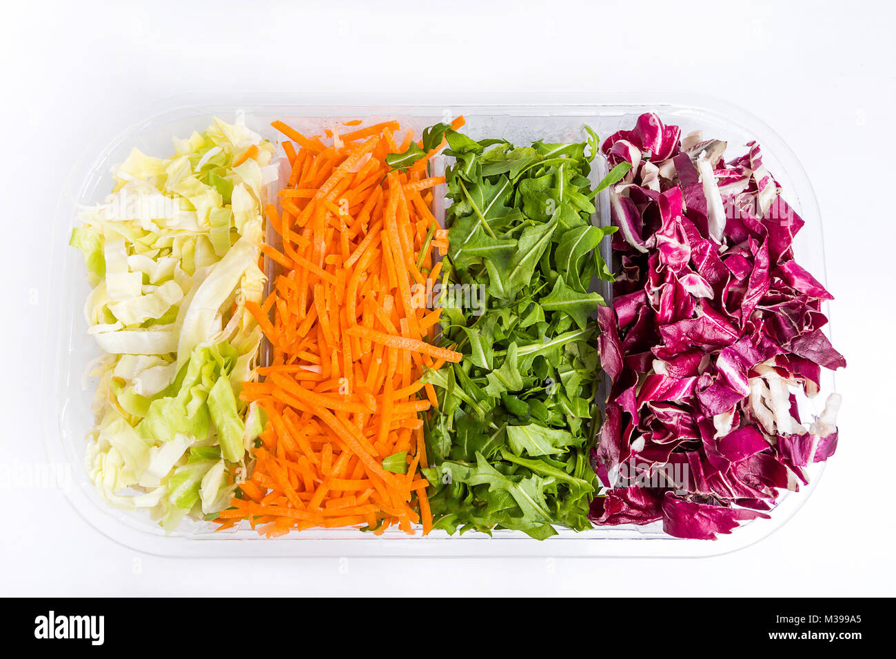 Mix salad vegetables in plastic box isolated on white background Stock ...