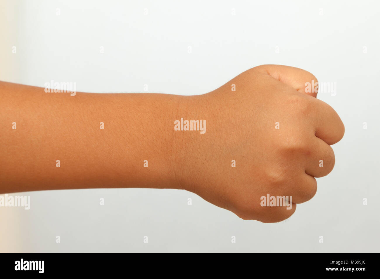 Child's fist, white background Stock Photo - Alamy