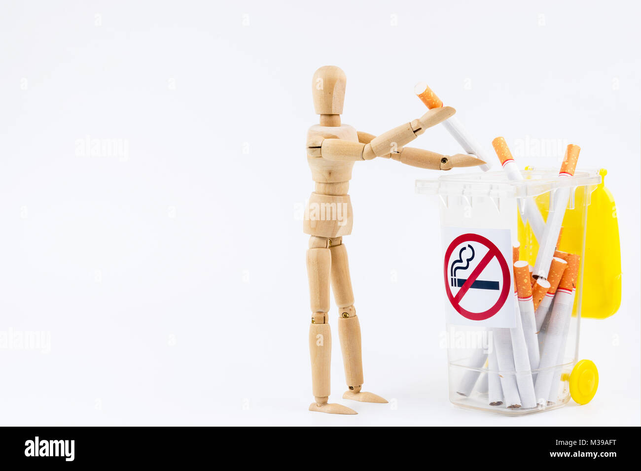 Wooden puppet take the cigarettes to dumps.No Smoking Day background ...